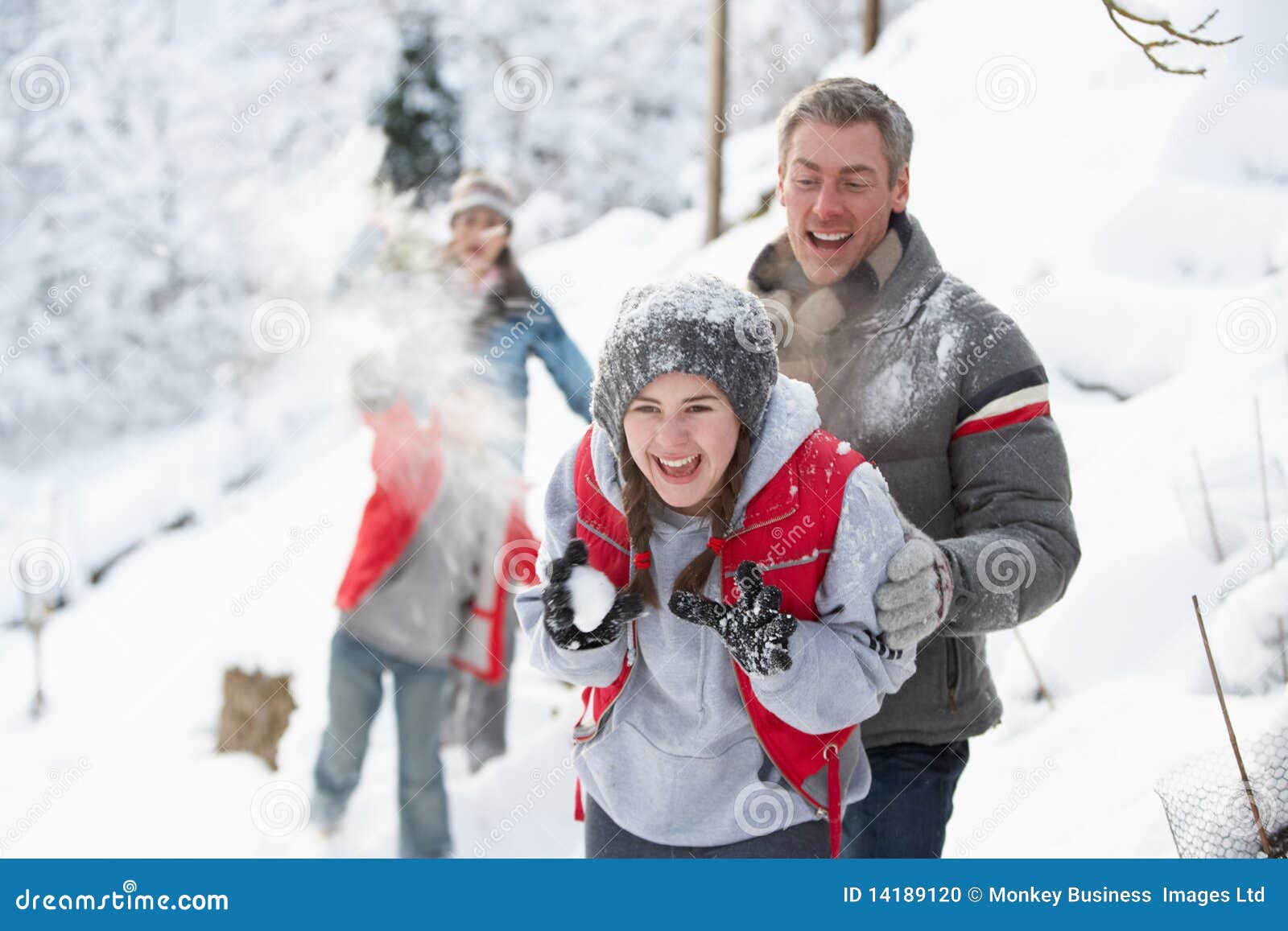 Young Family Having Snowball Fight Stock Photo - Image of laughter ...