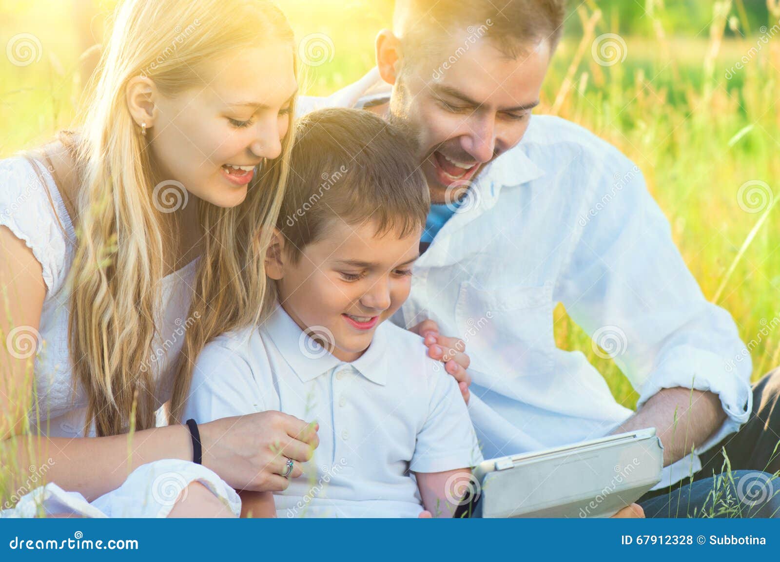 Young Family with Kid Using Tablet Pc in Summer Park Stock Photo ...
