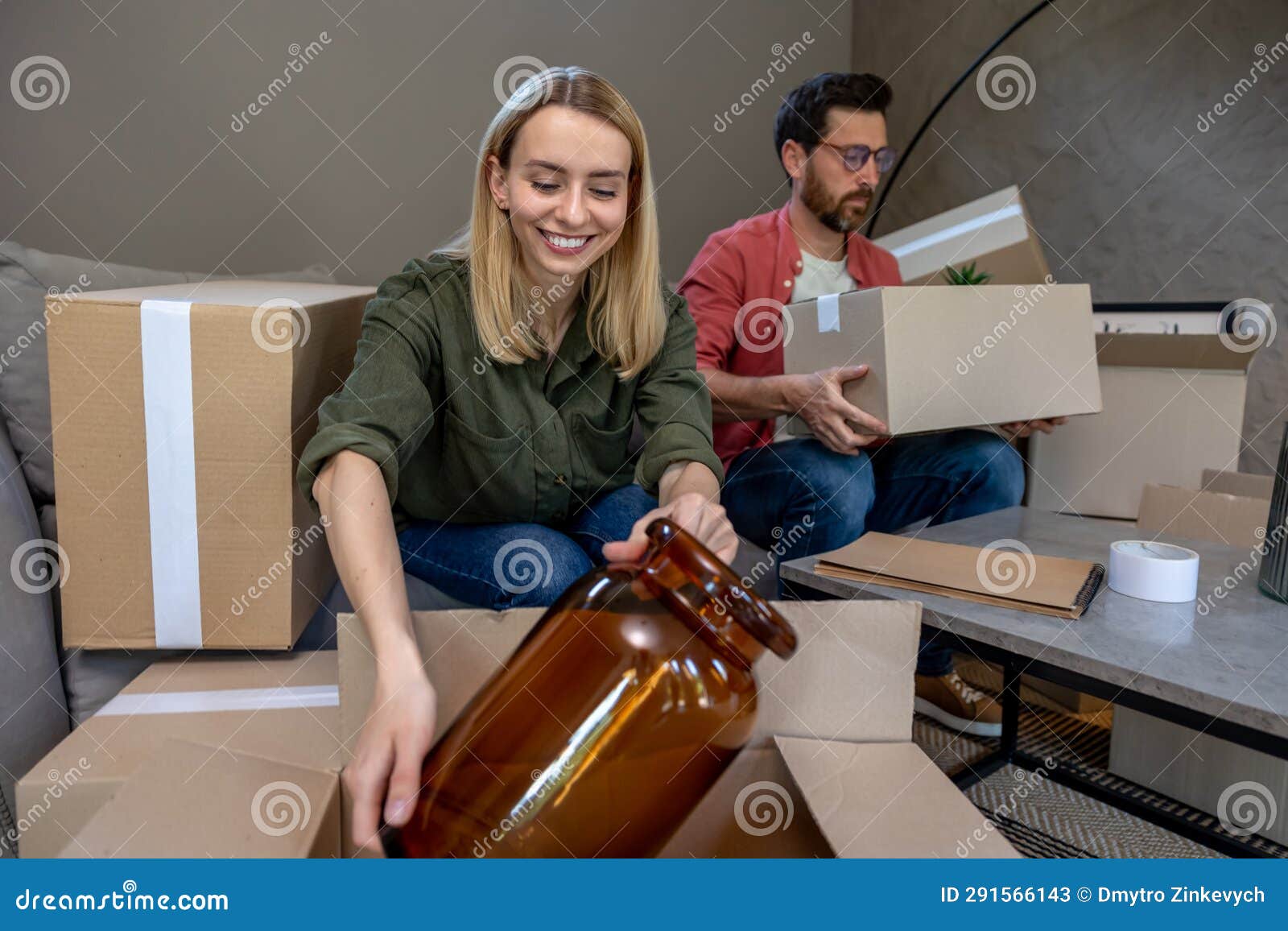Young Family Looking Involved while Packing Boxes for the Move Stock ...