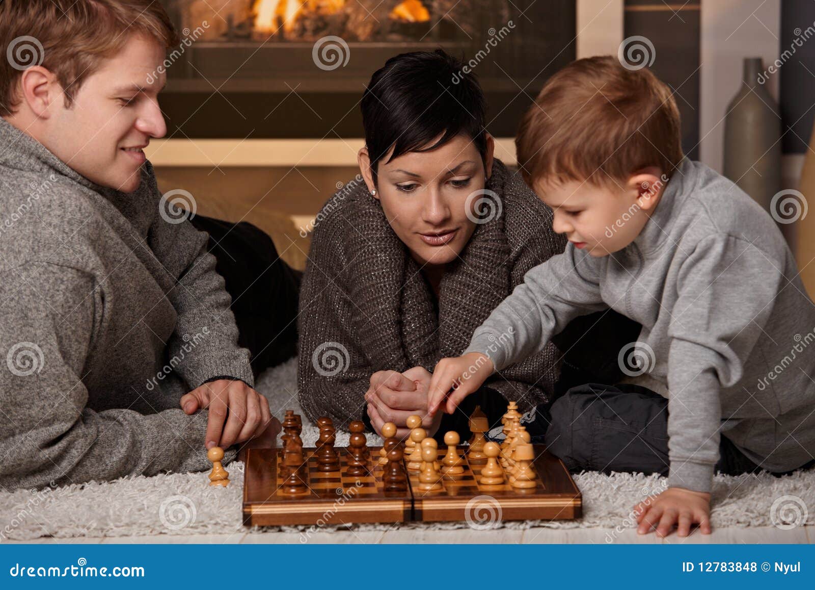 Young family playing chess stock photo. Image of adult - 12783848
