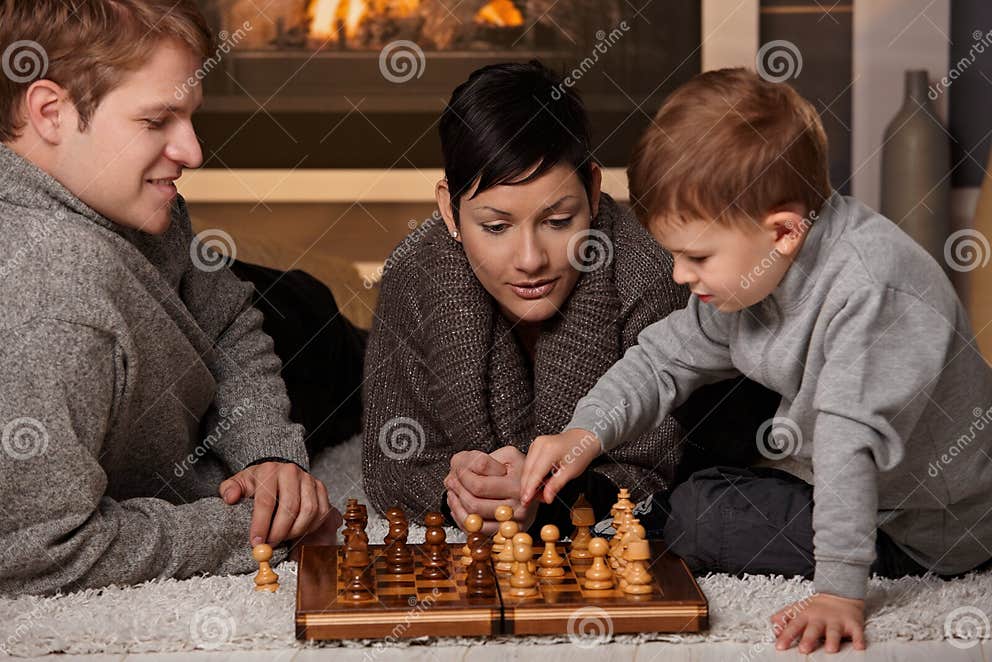Young family playing chess stock photo. Image of adult - 12783848