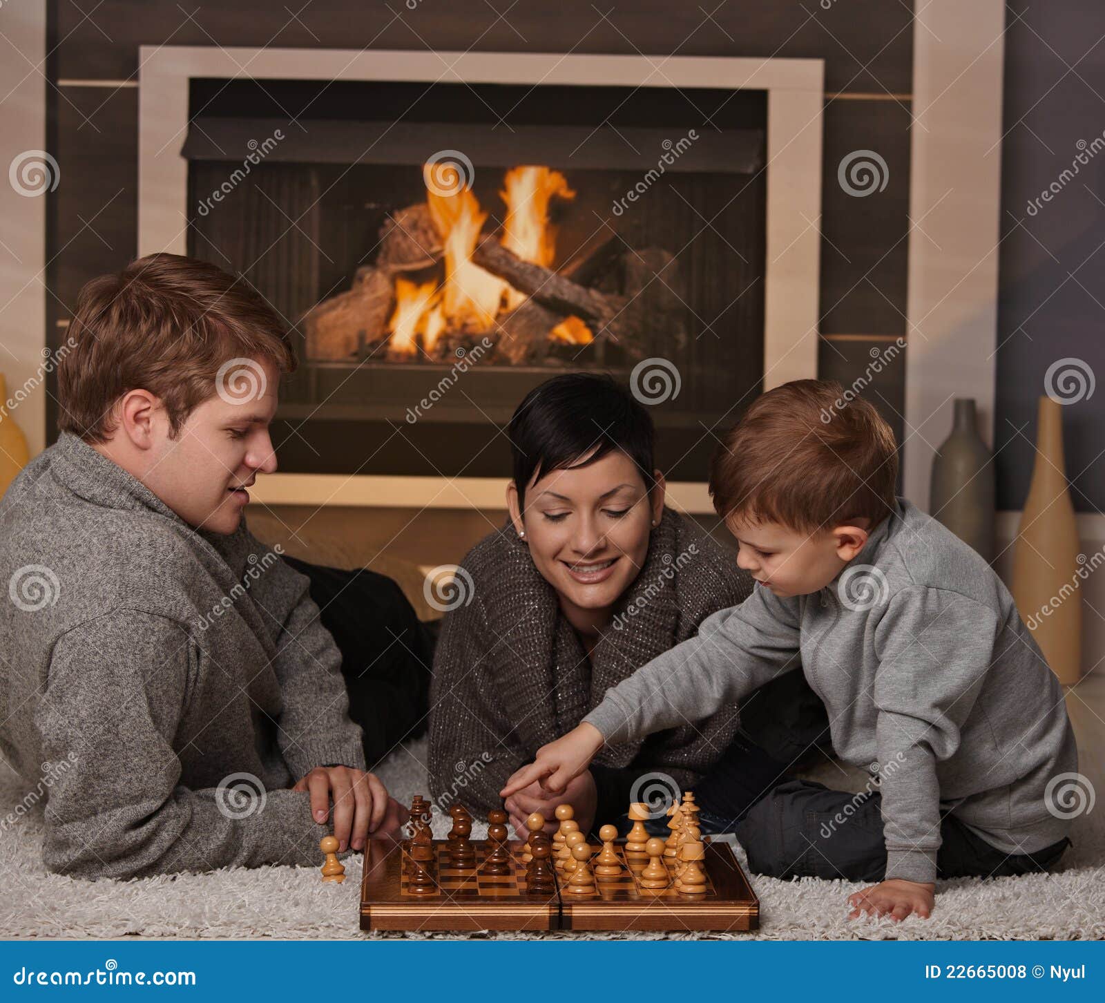Young family playing chess stock photo. Image of domestic - 22665008