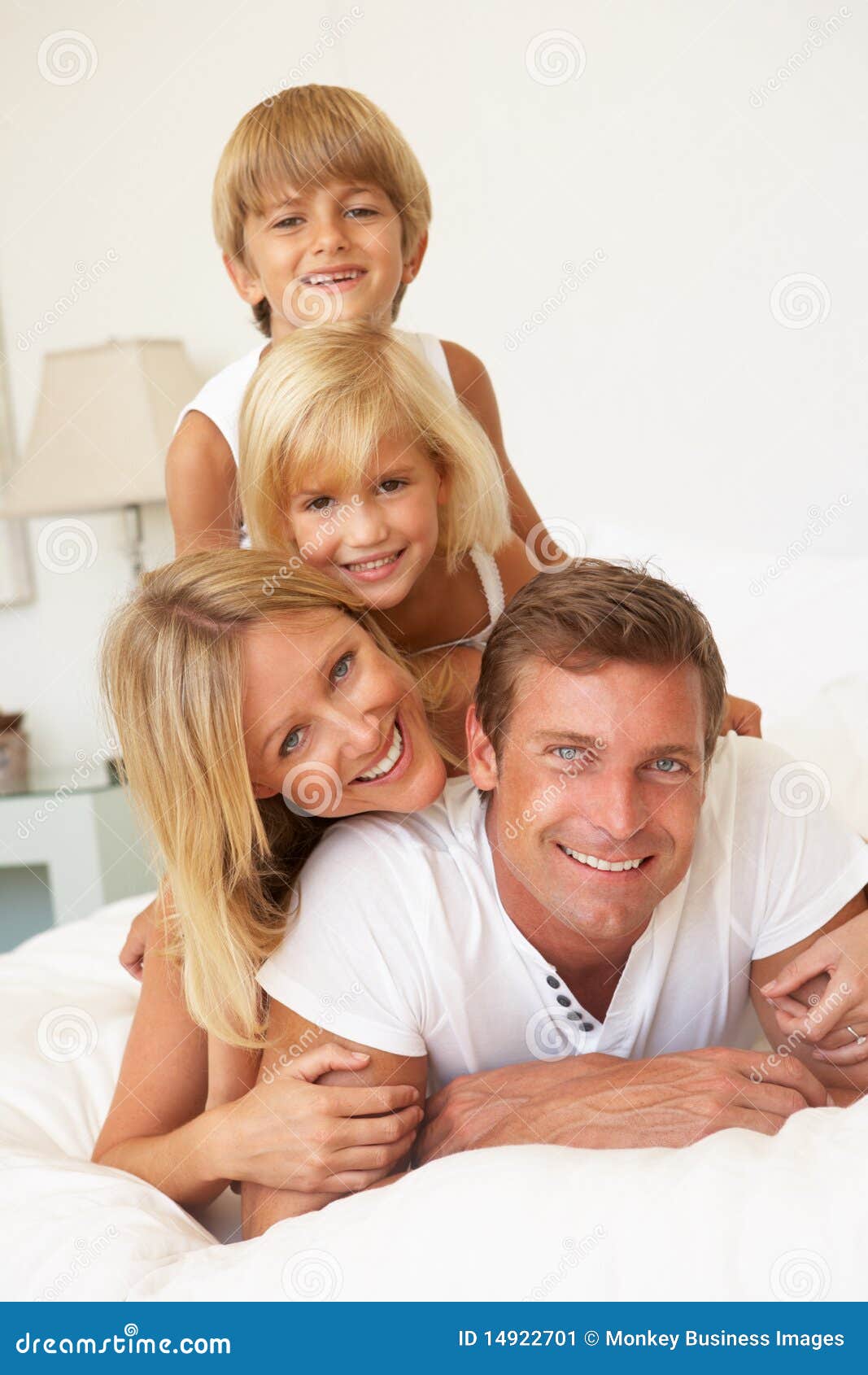 Young Family Relaxing in Bed Together Stock Image - Image of male ...