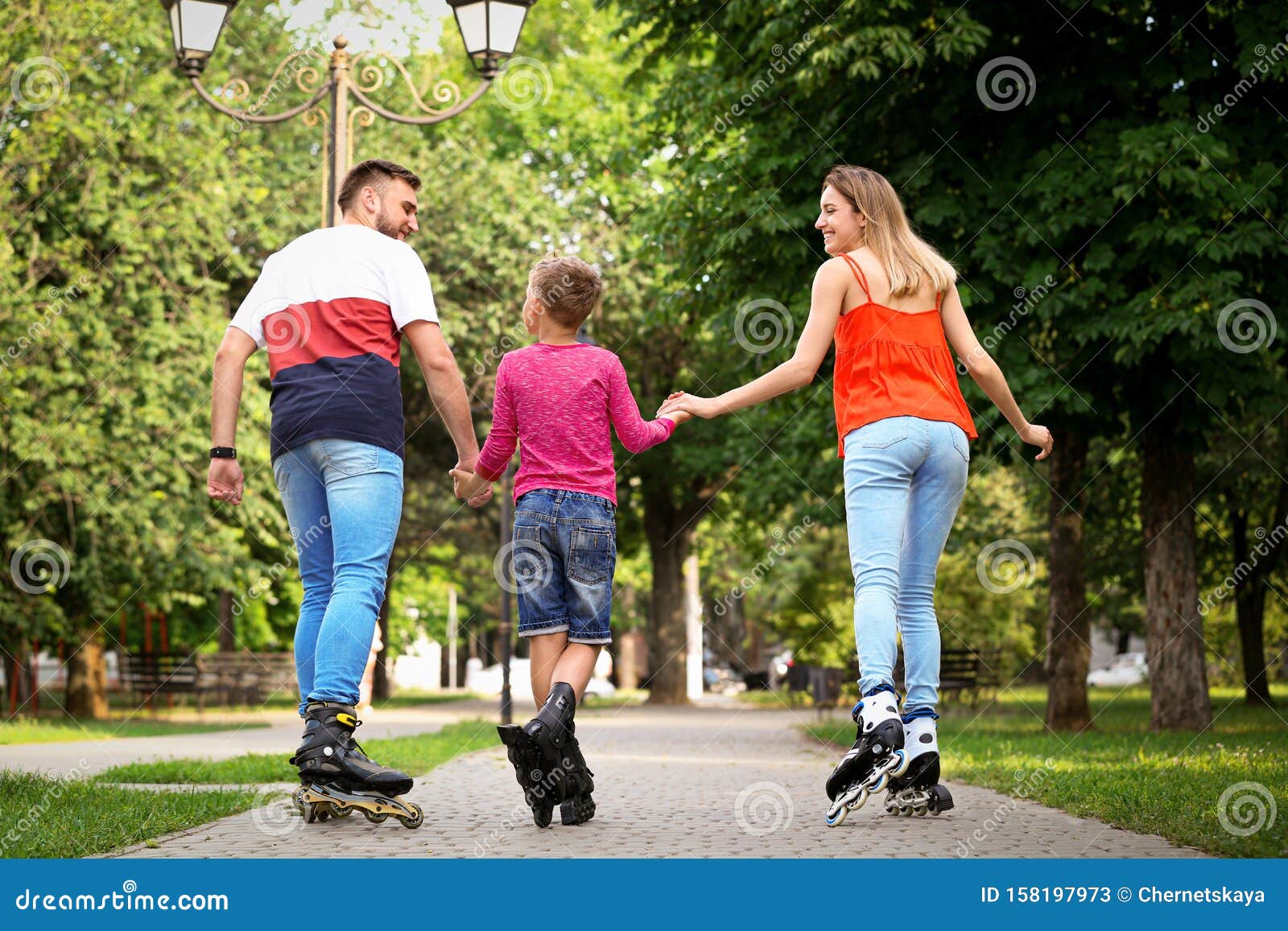 Young Family Roller Skating in Park Stock Image - Image of city, green ...
