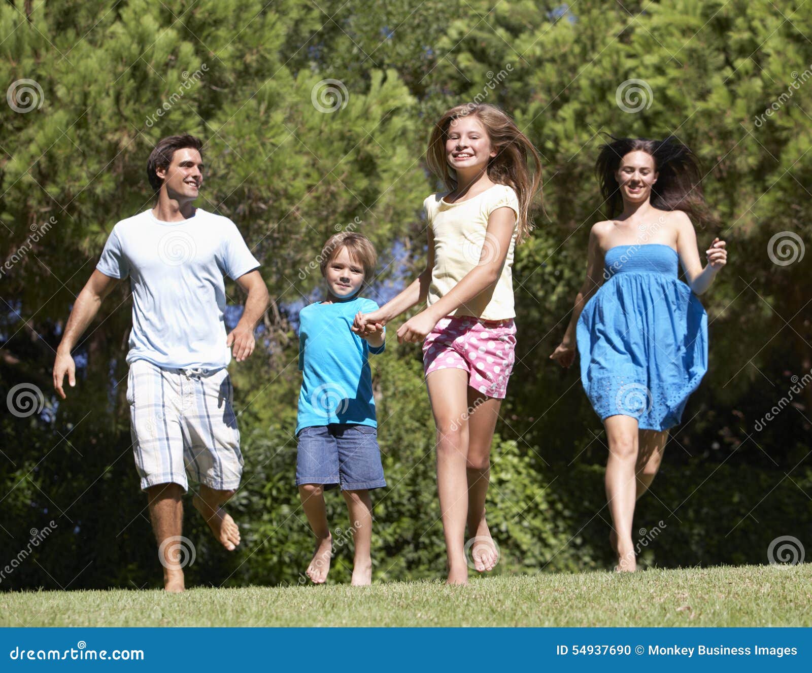 Young Family Running through Summer Field Stock Photo - Image of ...