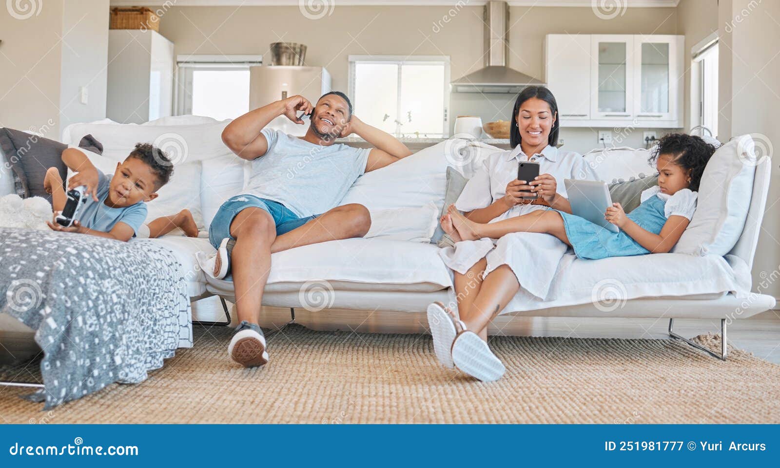 We All Chill Differently. a Young Family Sitting Together Using ...