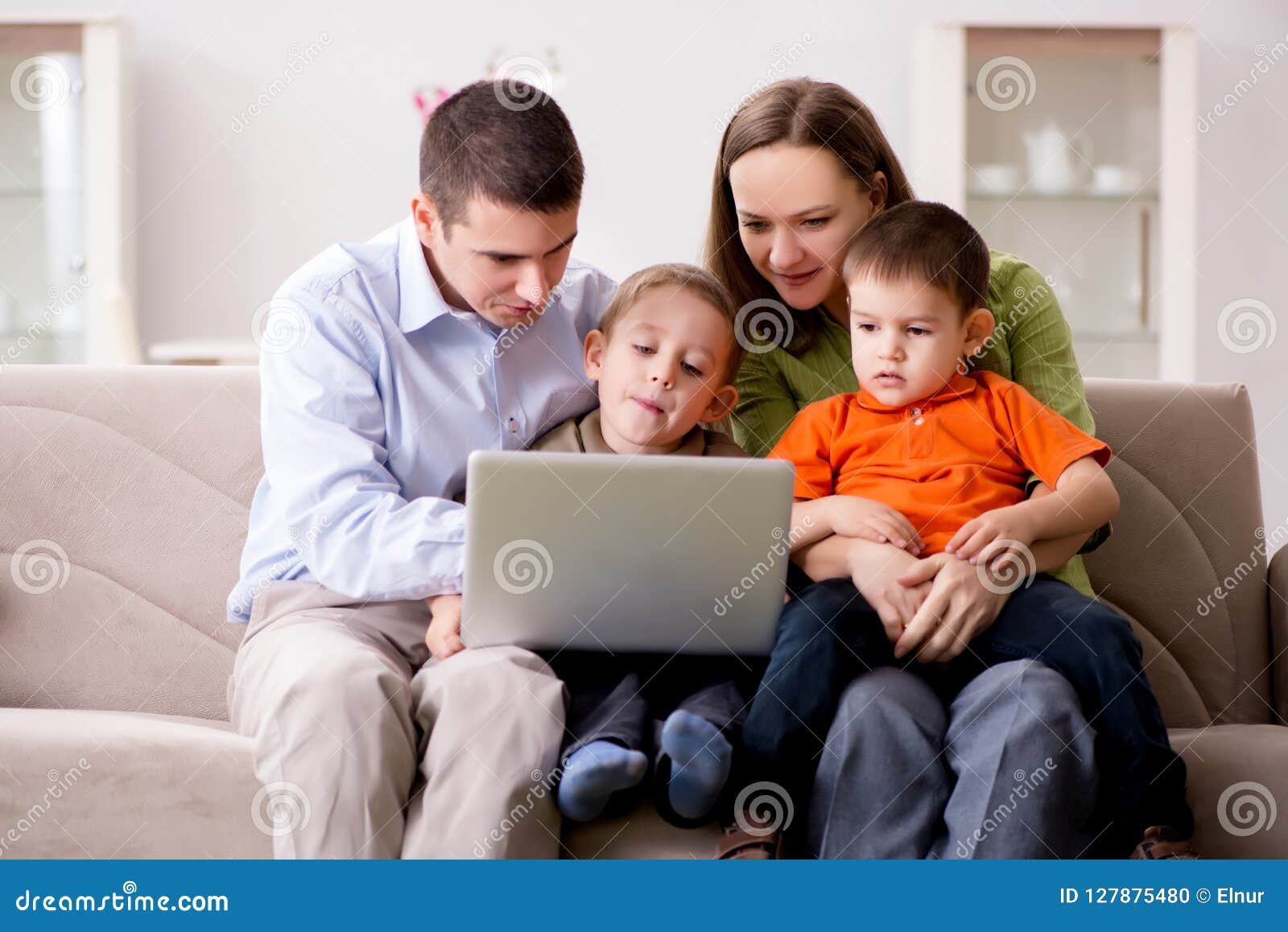 The Young Family Surfing Internet and Looking at Photos Stock Photo ...