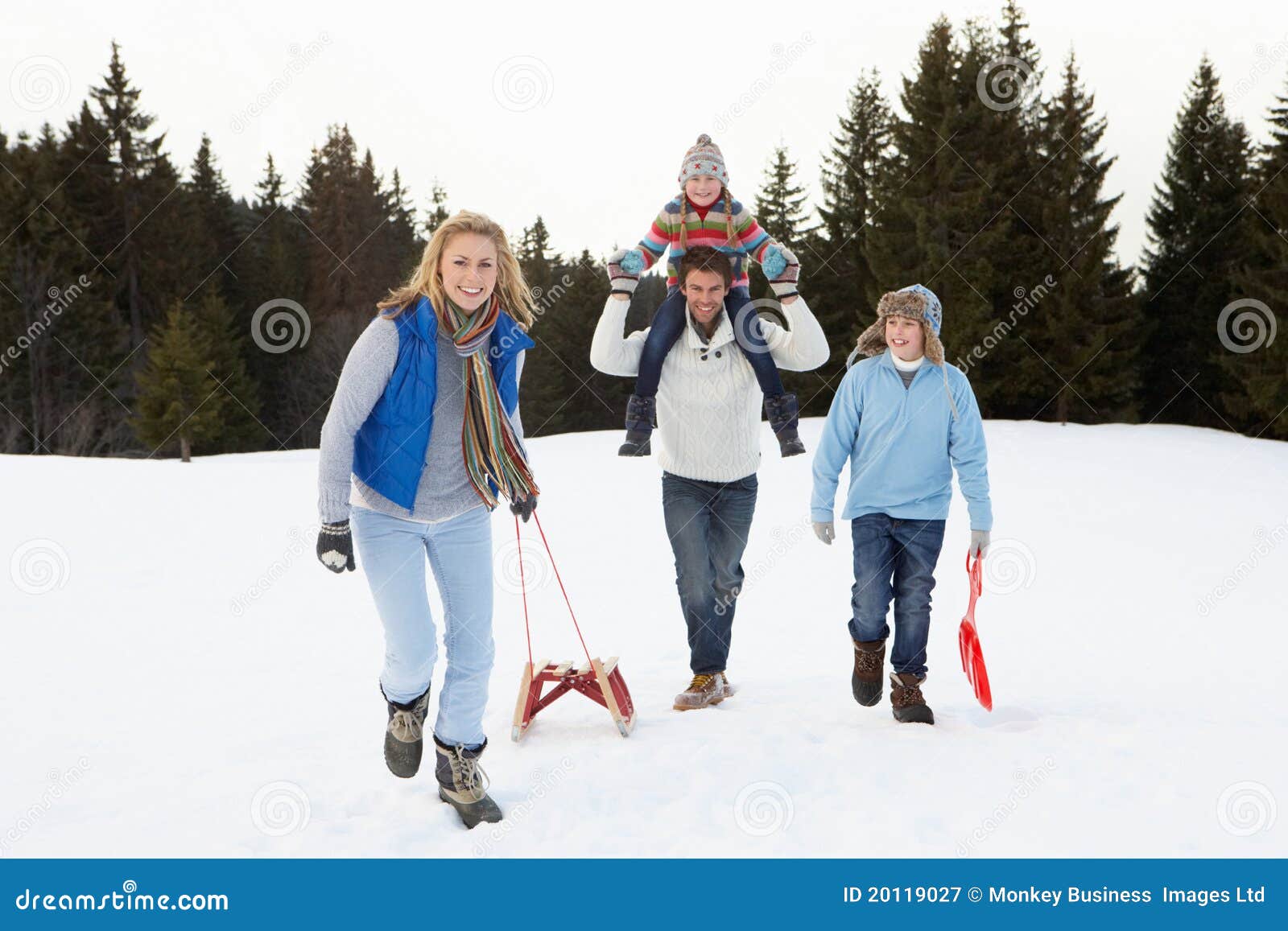 Young Family Walking through Snow with Sled Stock Image - Image of ...