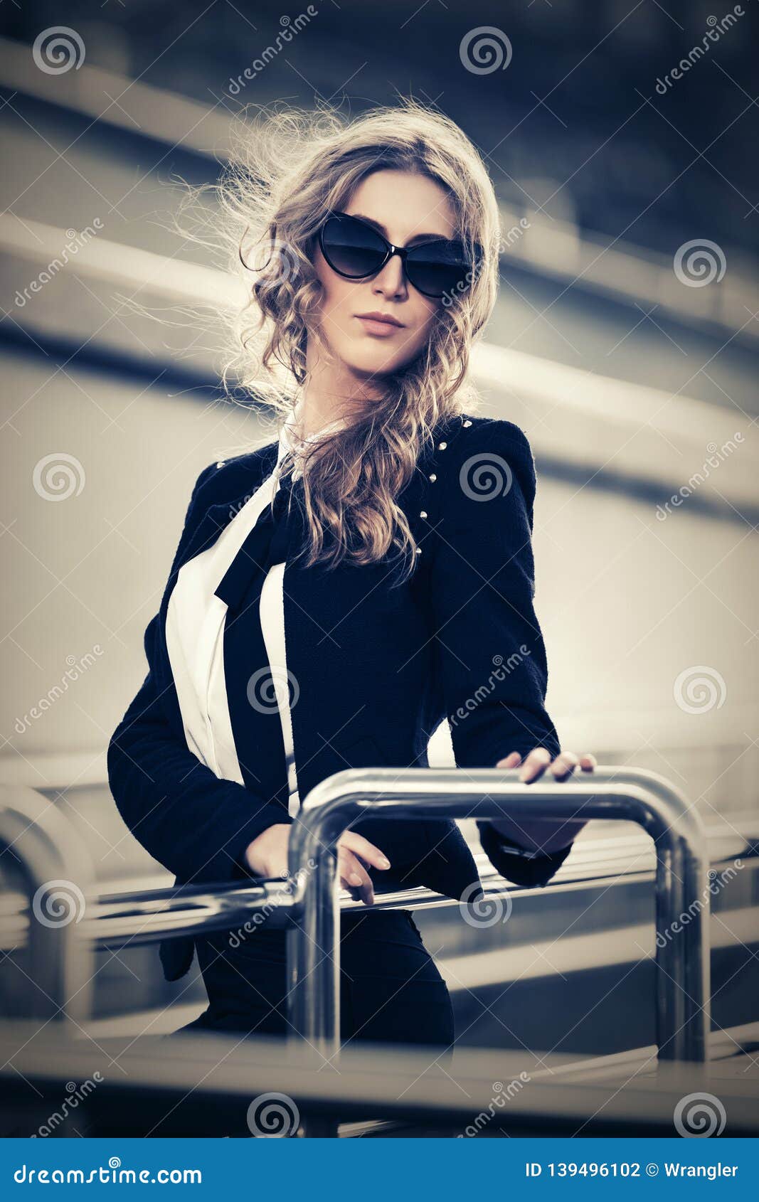 Young Fashion Blond Business Woman In Sunglasses Walking On City Street