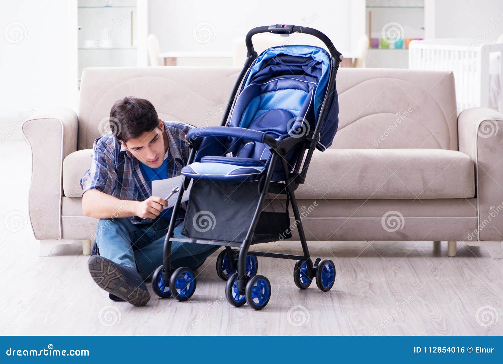 The Young Father Assembling Baby Pram at Home Stock Photo - Image of ...