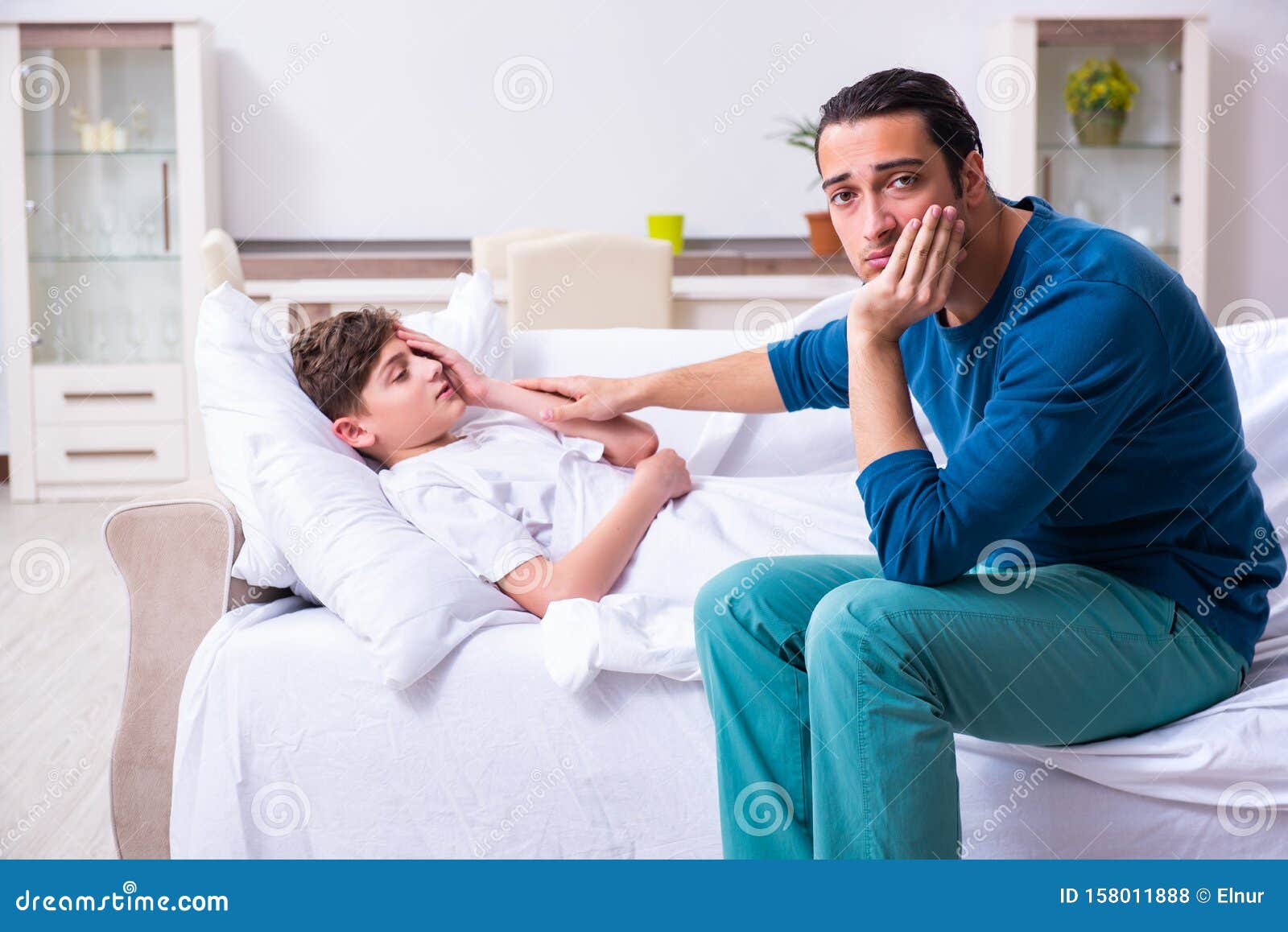 Young Father Caring for Sick Son Stock Photo - Image of home, high ...