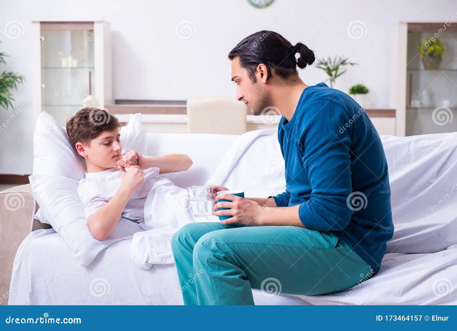Young Father Caring for Sick Son Stock Image - Image of father, pain ...