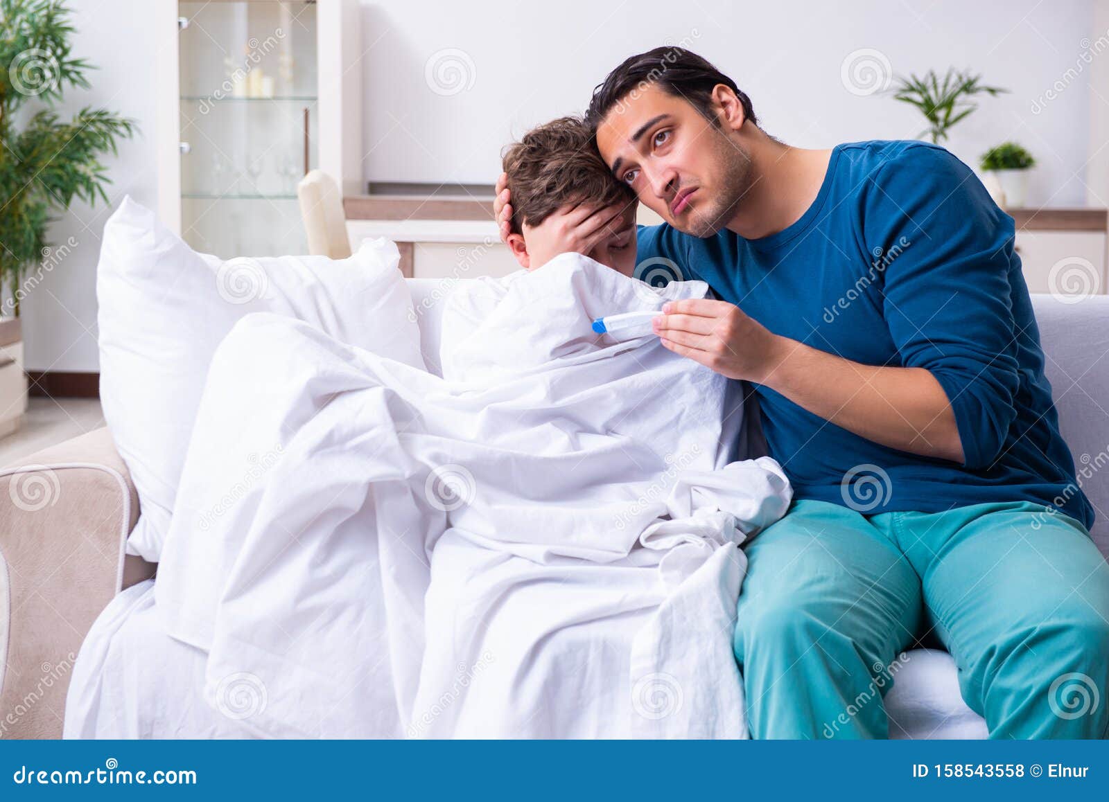Young Father Caring for Sick Son Stock Photo - Image of home, leave ...