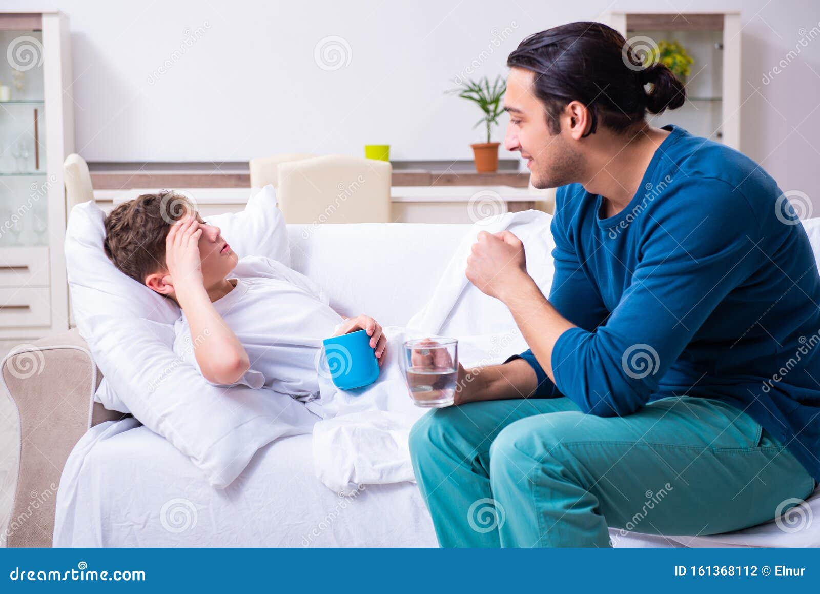 Young Father Caring for Sick Son Stock Photo - Image of medicine ...