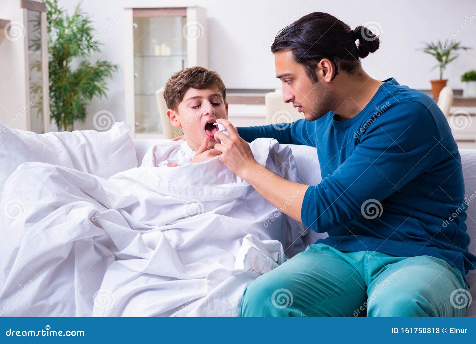 Young Father Caring for Sick Son Stock Photo - Image of medicine ...