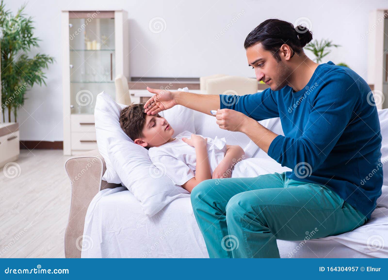 Young Father Caring for Sick Son Stock Image - Image of patient, sick ...