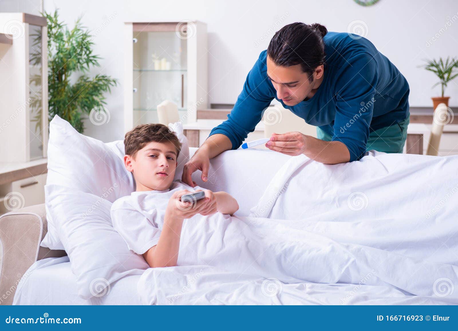 Young Father Caring for Sick Son Stock Image - Image of bored, patient ...