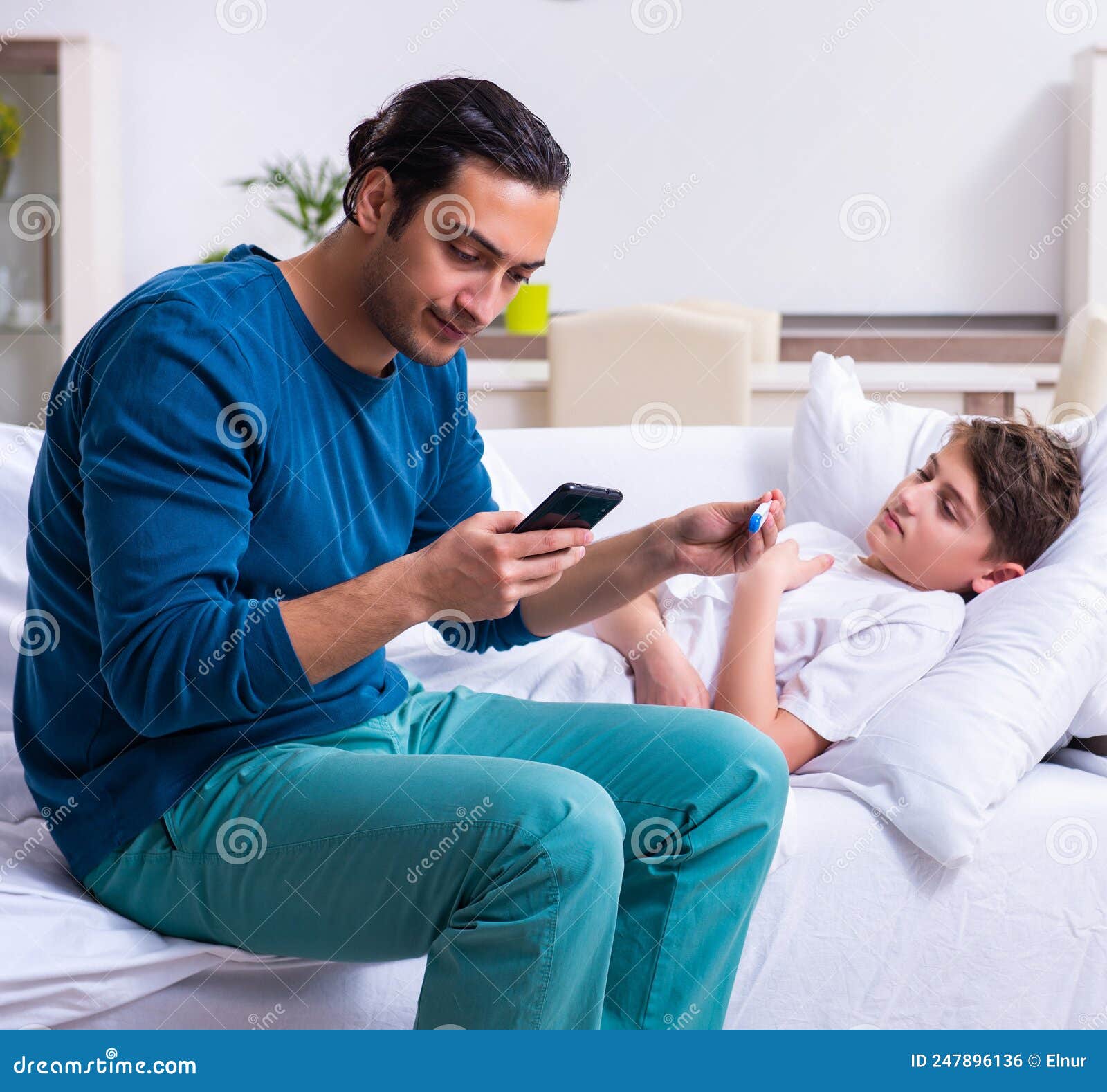 Young Father Caring for Sick Son Stock Photo - Image of medicine ...
