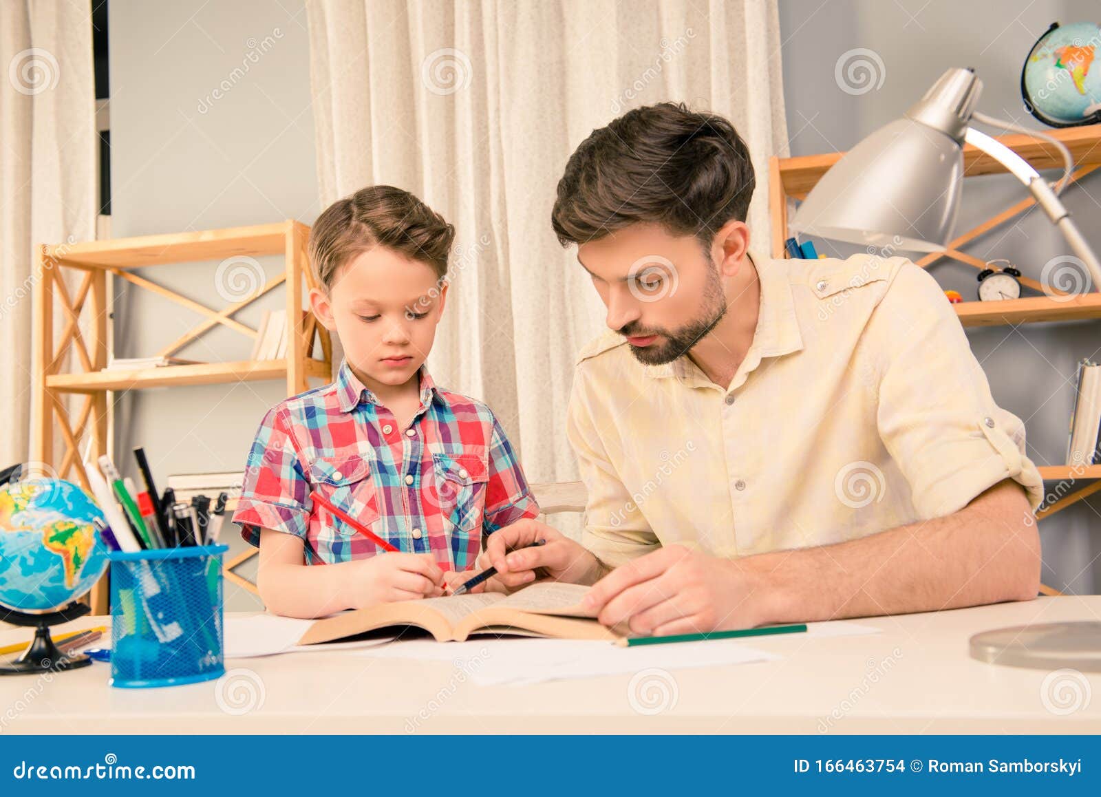 Young Father Helping His Little Son with Homework Stock Photo - Image ...