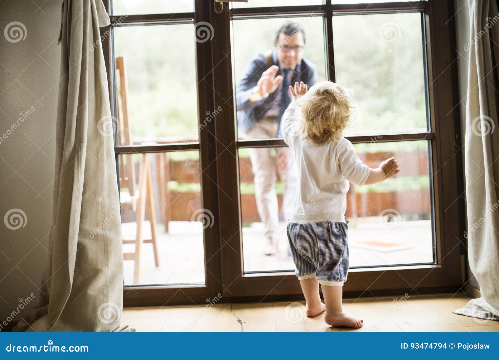 Young father leaving home. stock photo. Image of curtain - 93474794