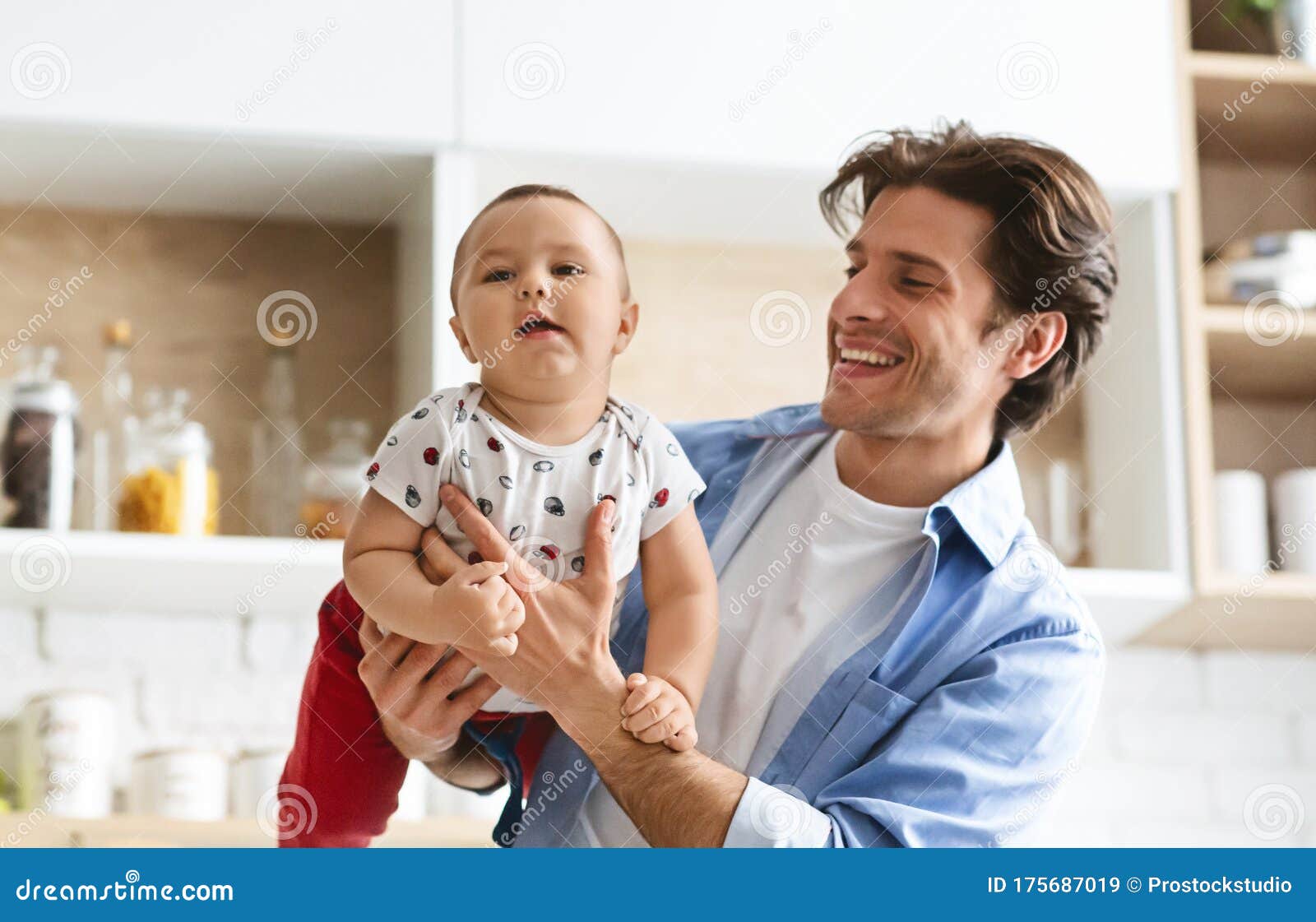 Young Father Raising His Baby Son Like on Plane at Kitchen Stock Image ...
