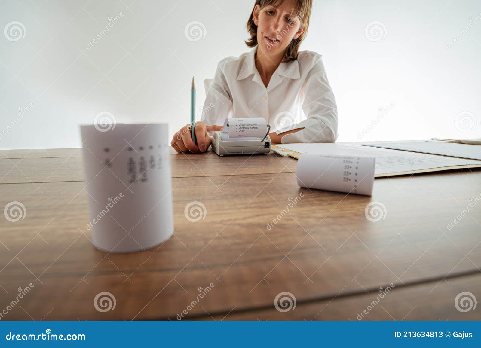 Young Female Accountant Using Adding Machine Working at Her Desk Stock ...