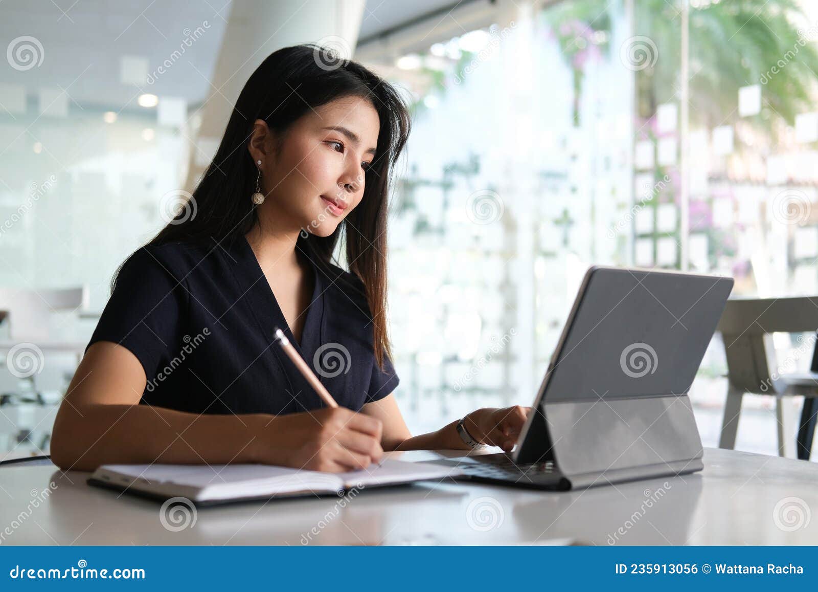 A Young Female Administrative Assistant Making Notes of Working ...