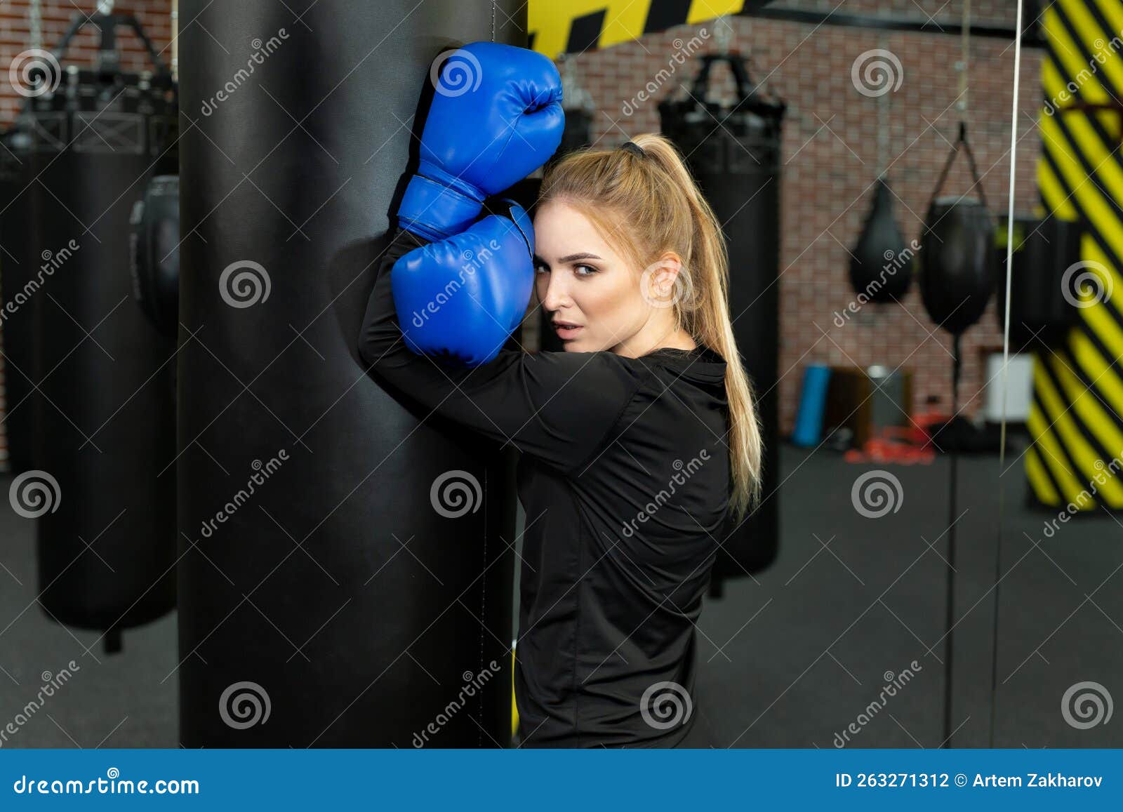 Young Female Boxer Hugging Punching Bag and Smiling at Camera. Stock ...