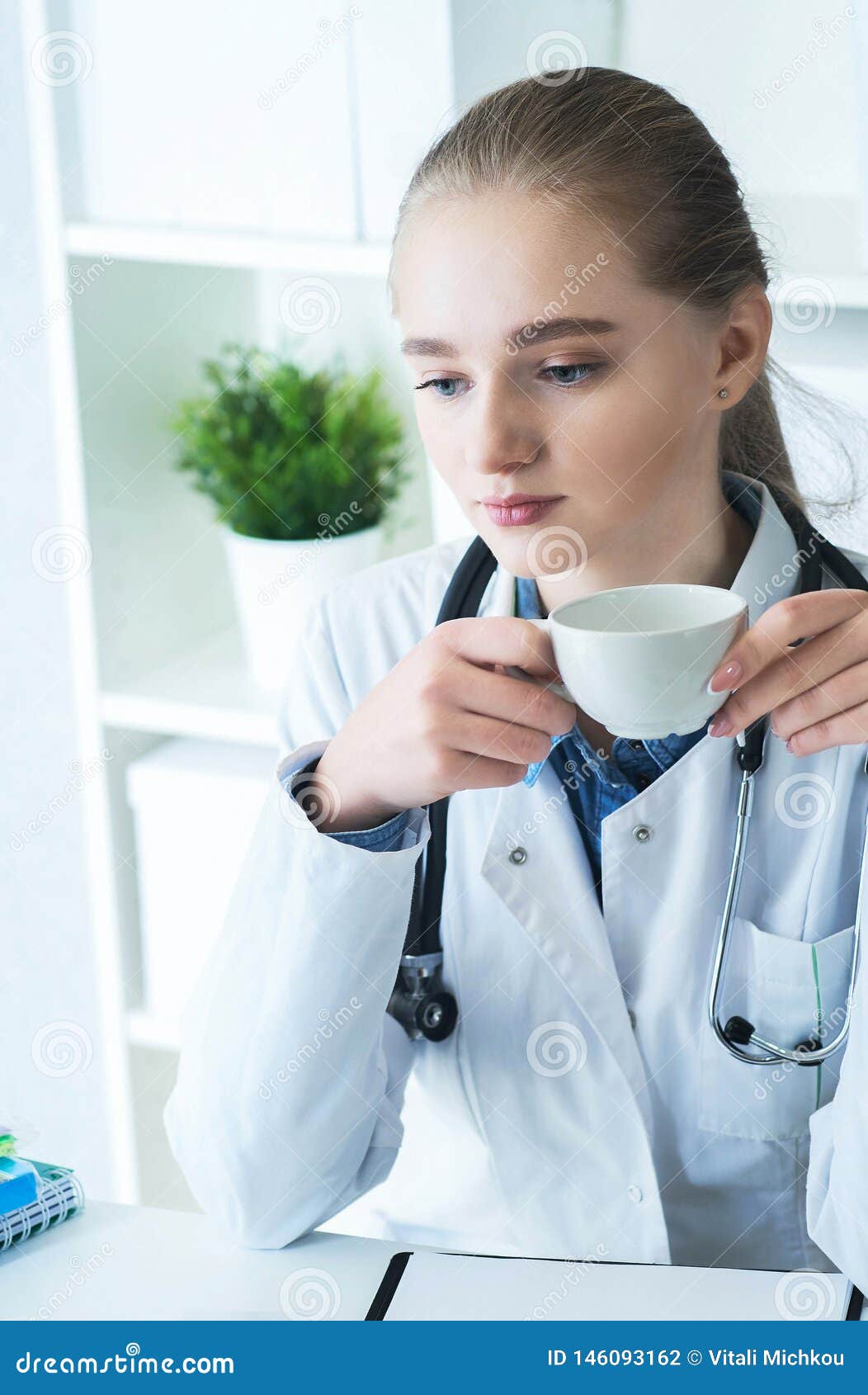 Young Female Caucasian Doctor Having A Break And Drinking Coffee
