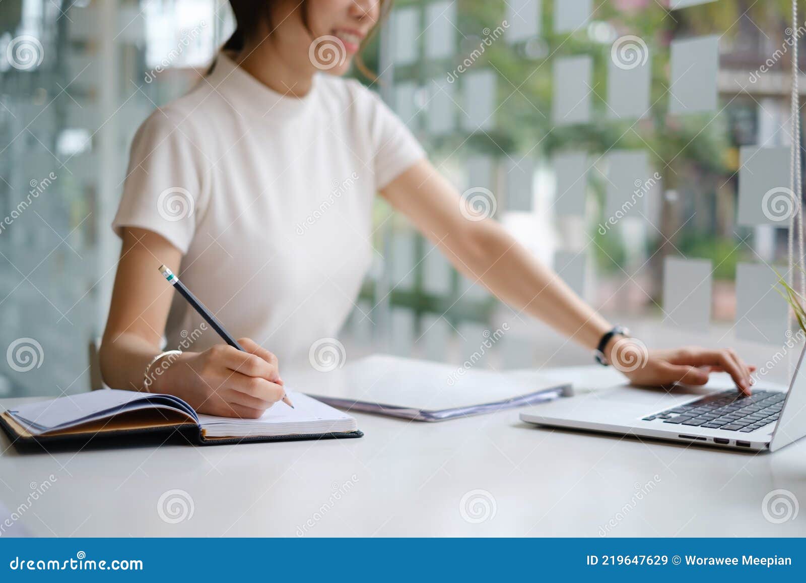 Young Female College Taking Notes and Using Highlighter. Focused ...