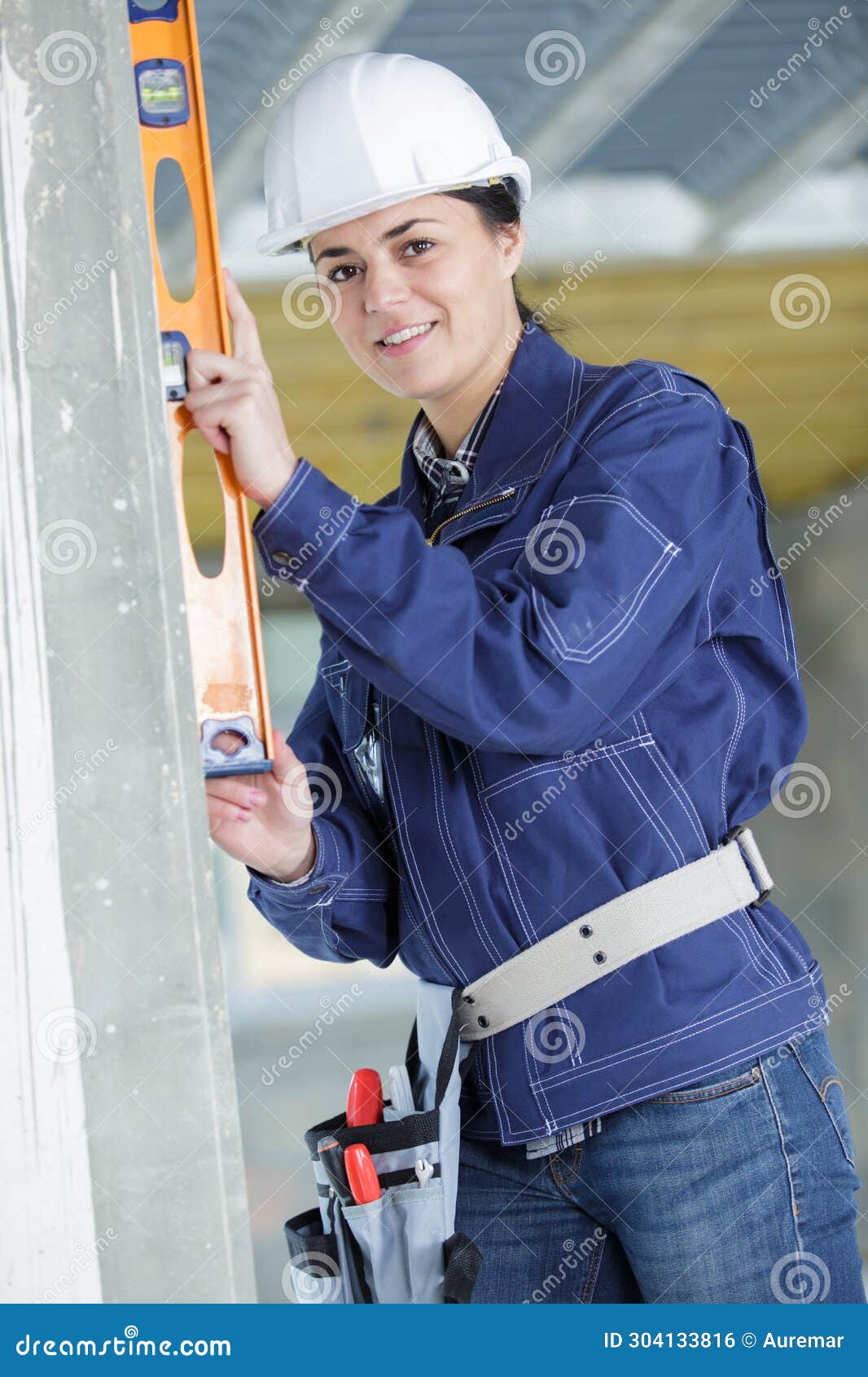 Young Female Construction Worker Checking Level Wall Stock Photo ...