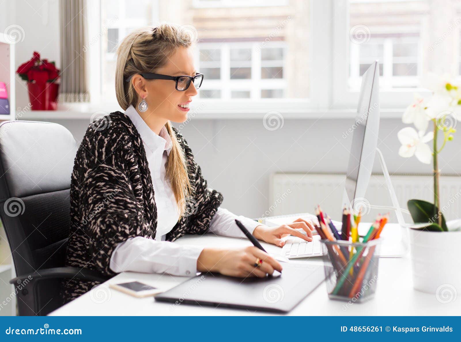 Young Female Designer Using Graphics Tablet while Working with Computer ...