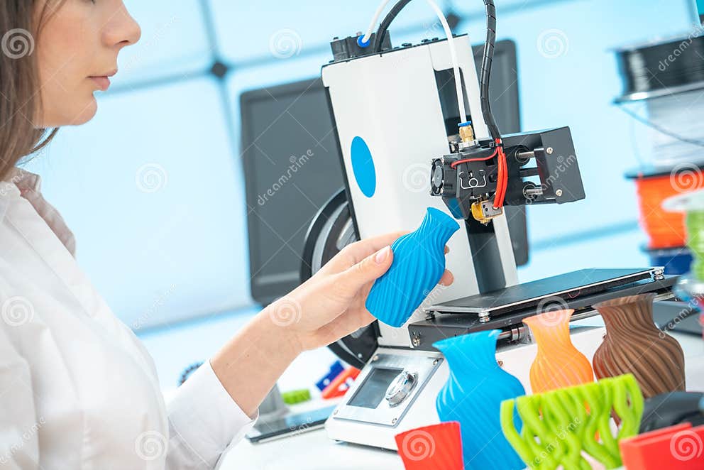 Young Female Designer Works with a 3D Printer in a Design Studio Stock ...