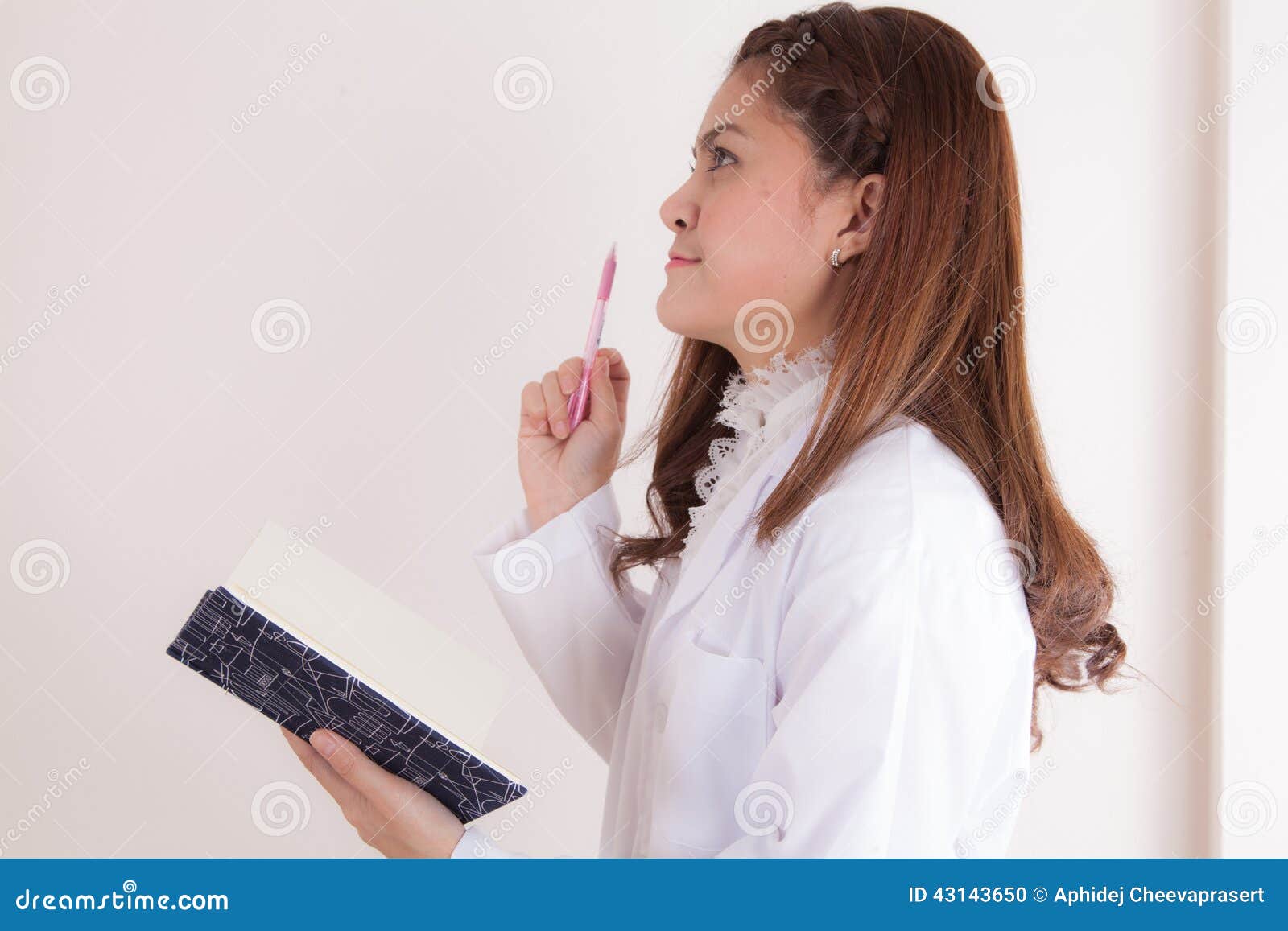 Young Female Doctor or Nurse Making a Note in Her Diary Stock Photo ...