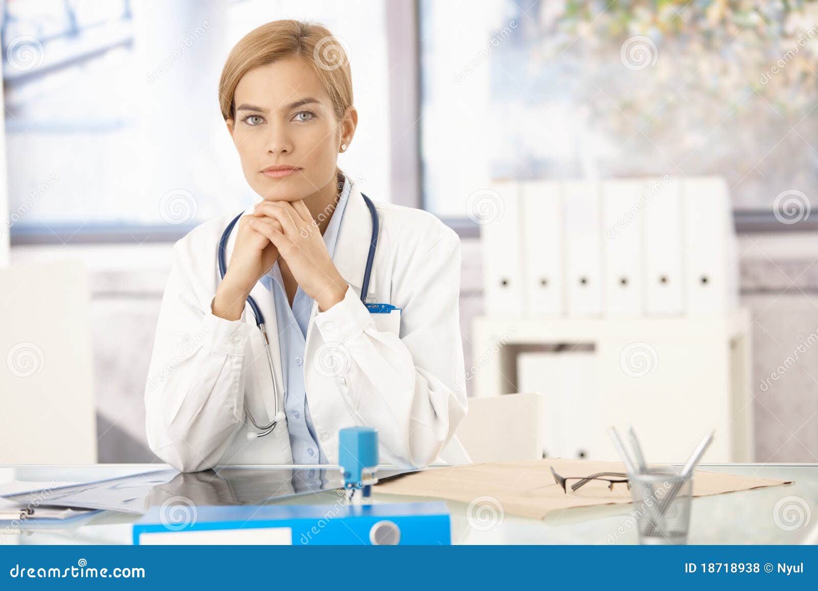 Young Female Doctor Sitting at Desk Stock Photo - Image of expertise ...