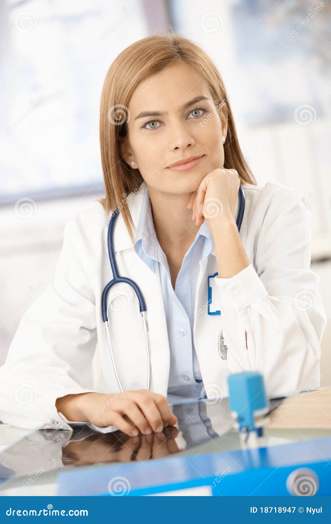 Young Female Doctor Sitting at Desk in Office Stock Image - Image of ...