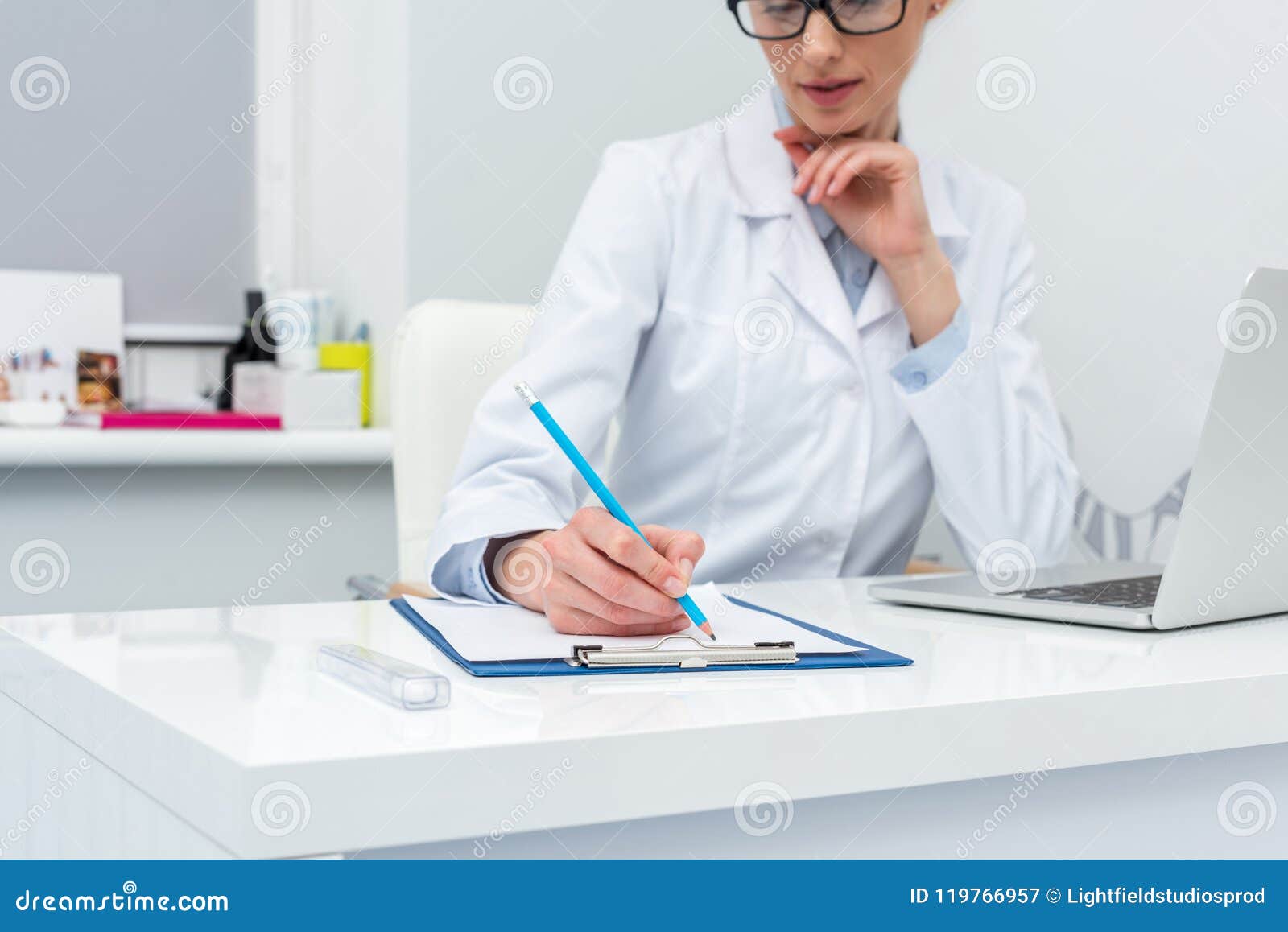 Young Female Doctor at Workplace Writing Stock Image - Image of gadget ...