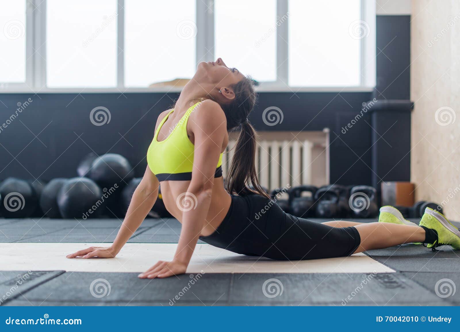 Young Female Doing Back Stretching Exercise, Fit Woman Warming-up in ...
