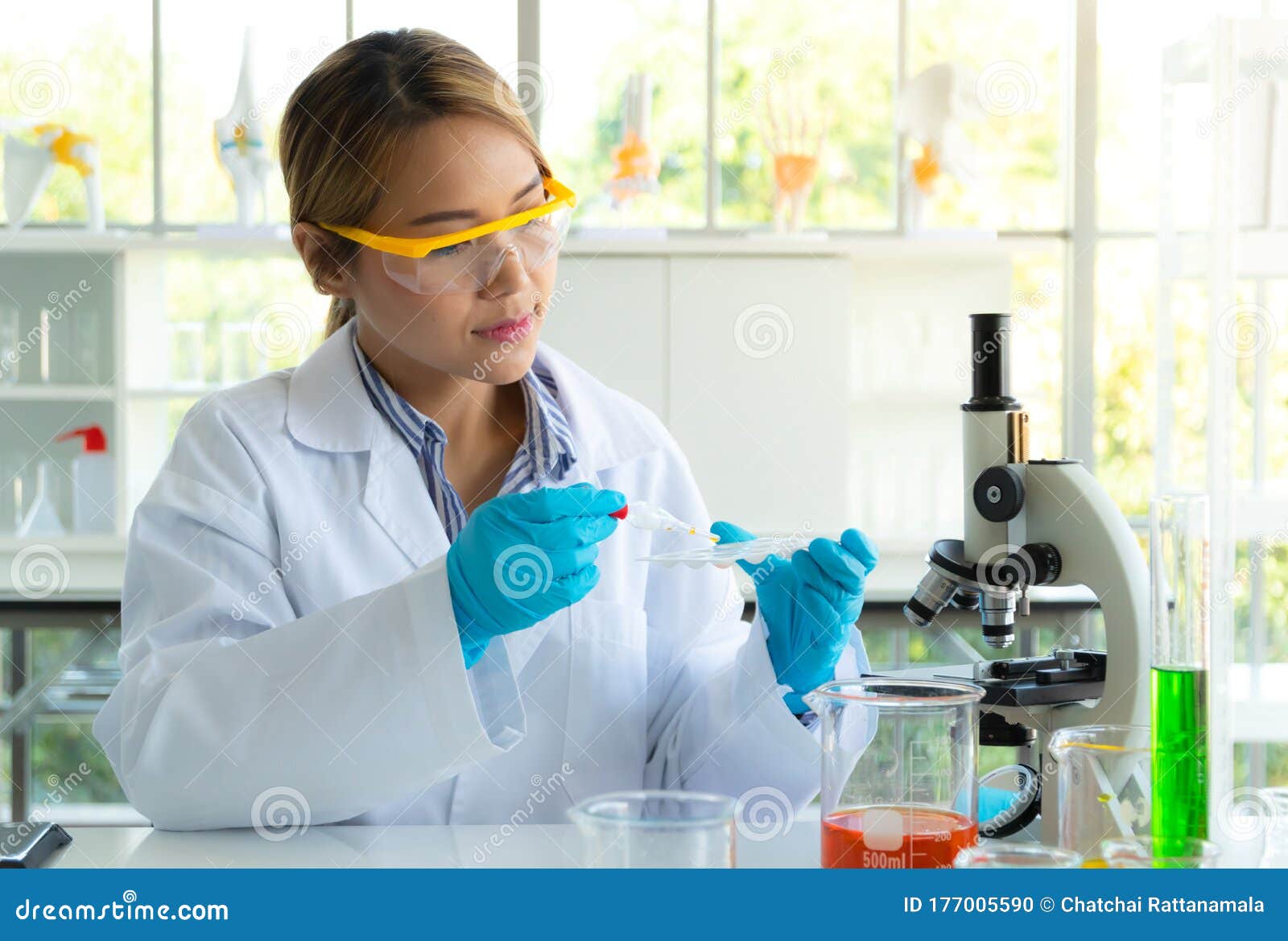 Young Female Doing Experiments and Researchers Working in the ...