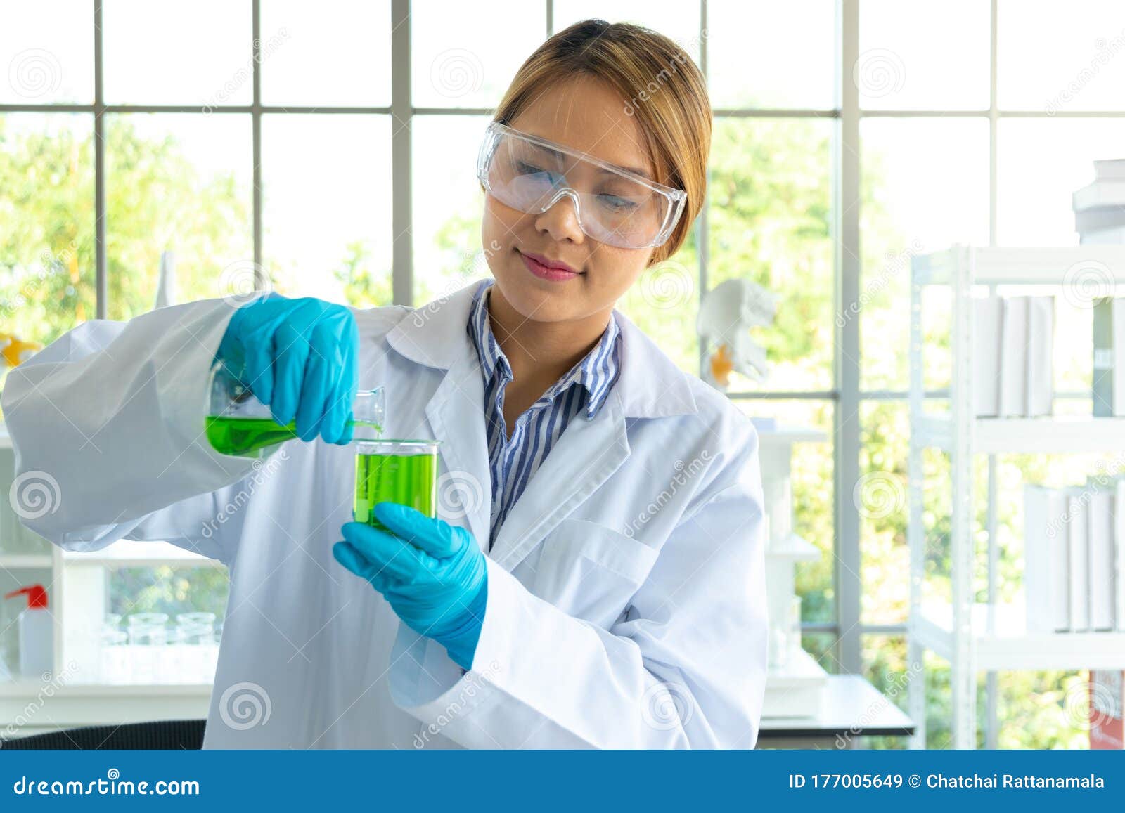 Young Female Doing Experiments and Researchers Working in the ...