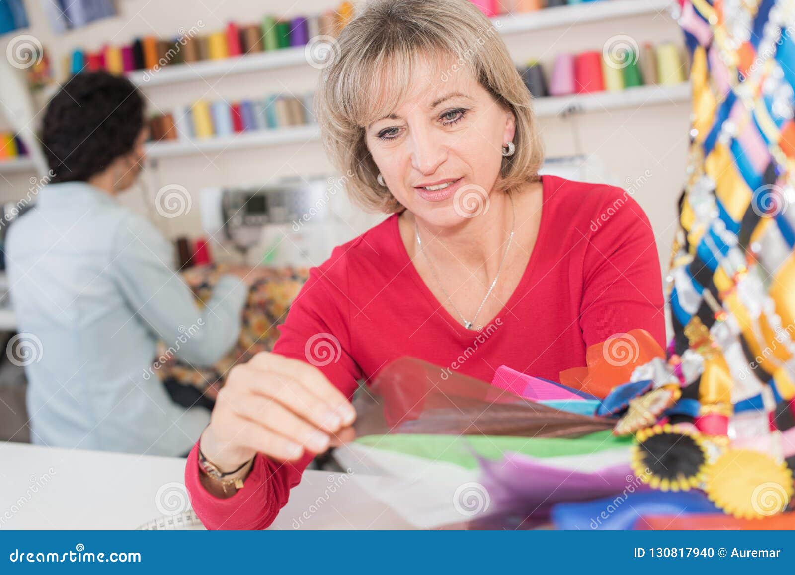 Young Female Dressmaker Choosing Material Stock Photo - Image of ...