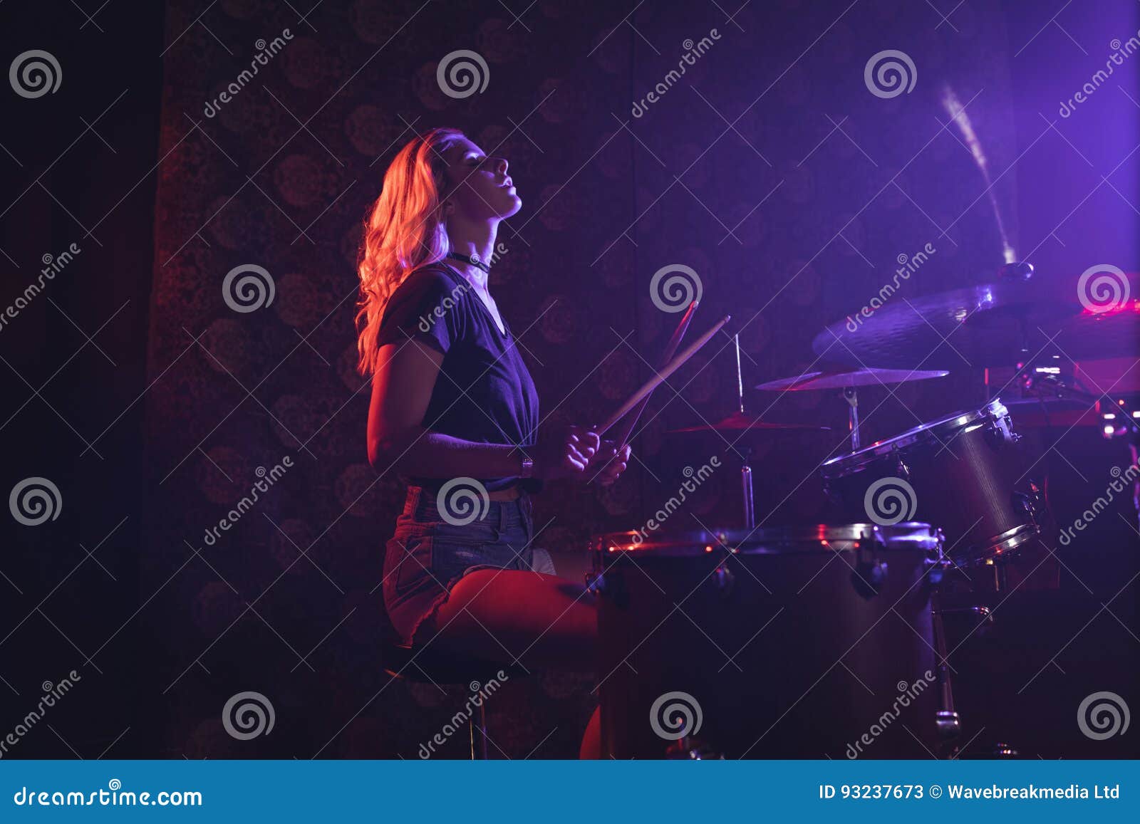 Young Female Drummer Performing in Illuminated Nightclub Stock Image ...