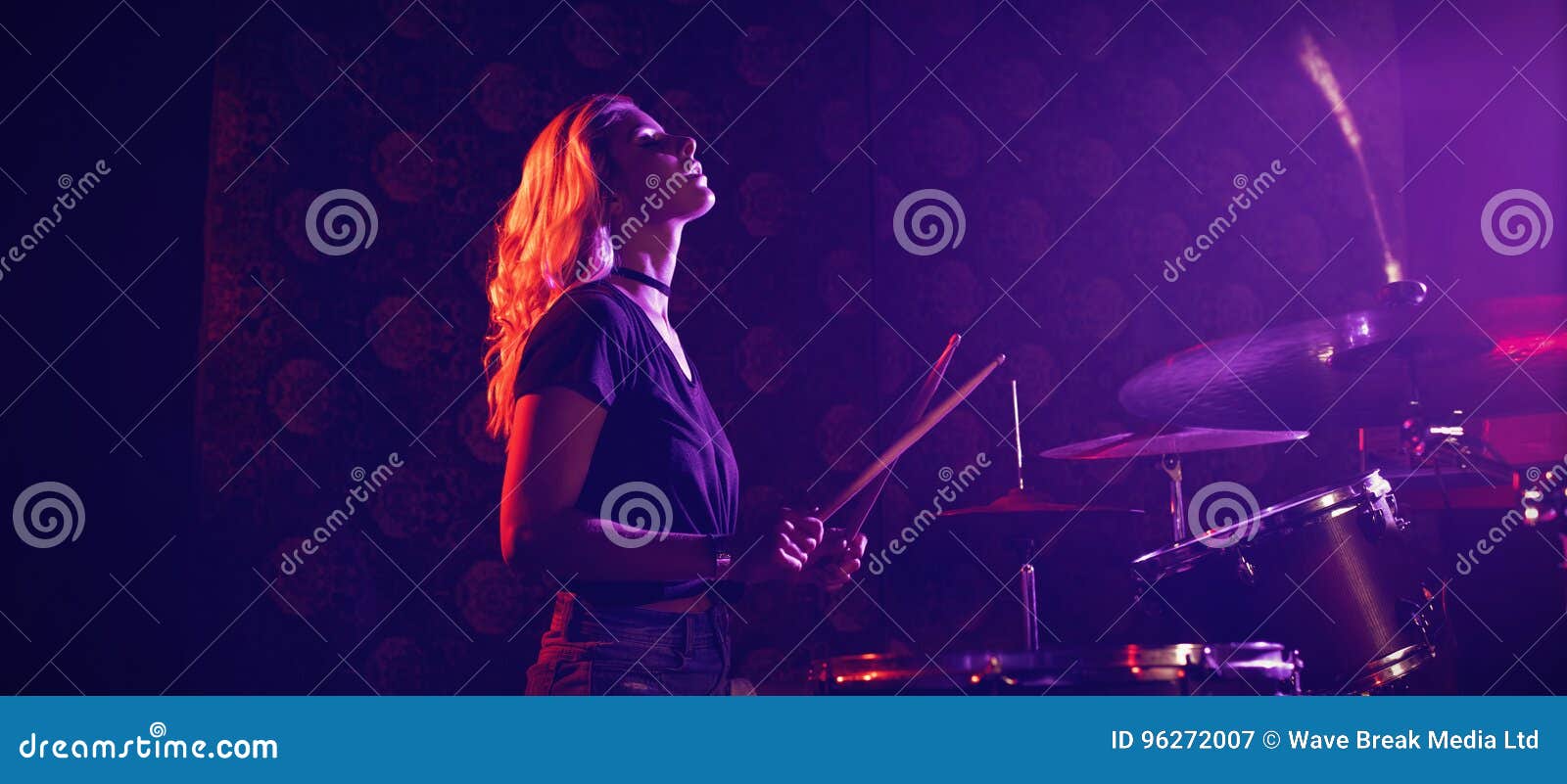 Young Female Drummer Performing in Illuminated Nightclub Stock Image ...