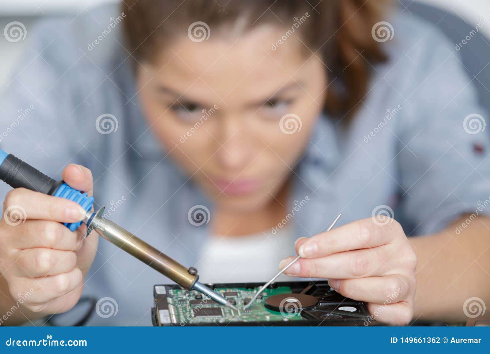 Female Electronic Engineer Checking Electronic Circuit In Laboratory ...