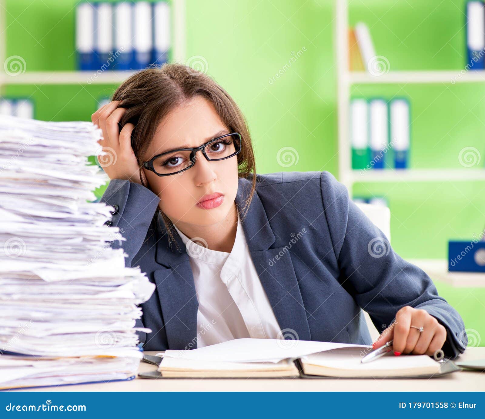 Young Female Employee Very Busy with Ongoing Paperwork Stock Photo ...