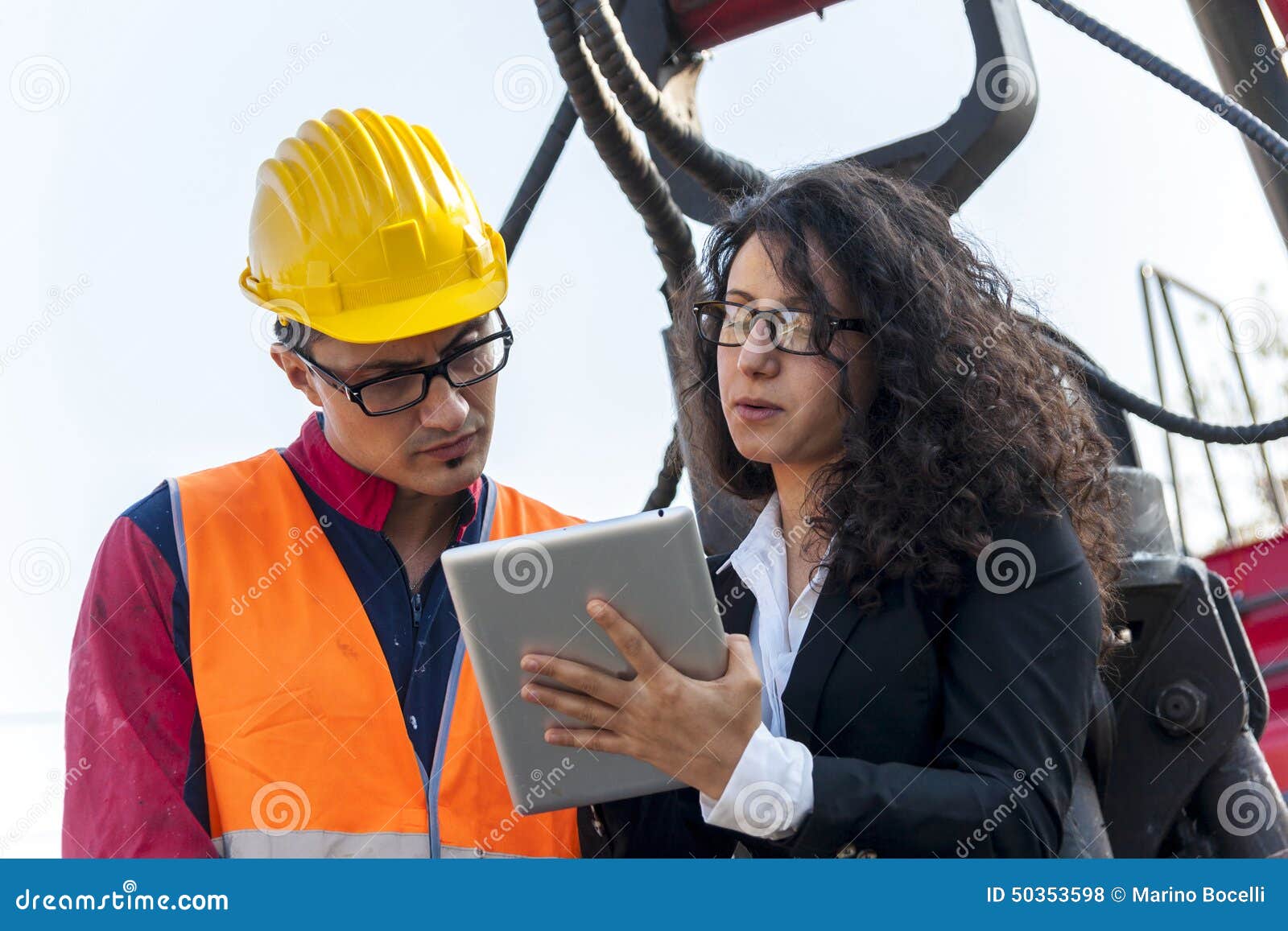 Young Female Engineer Talks about Working Stock Photo - Image of collar ...