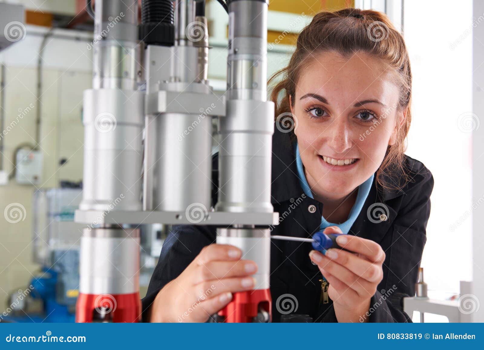 Young Female Engineer Working on Machine in Factory Stock Image - Image ...