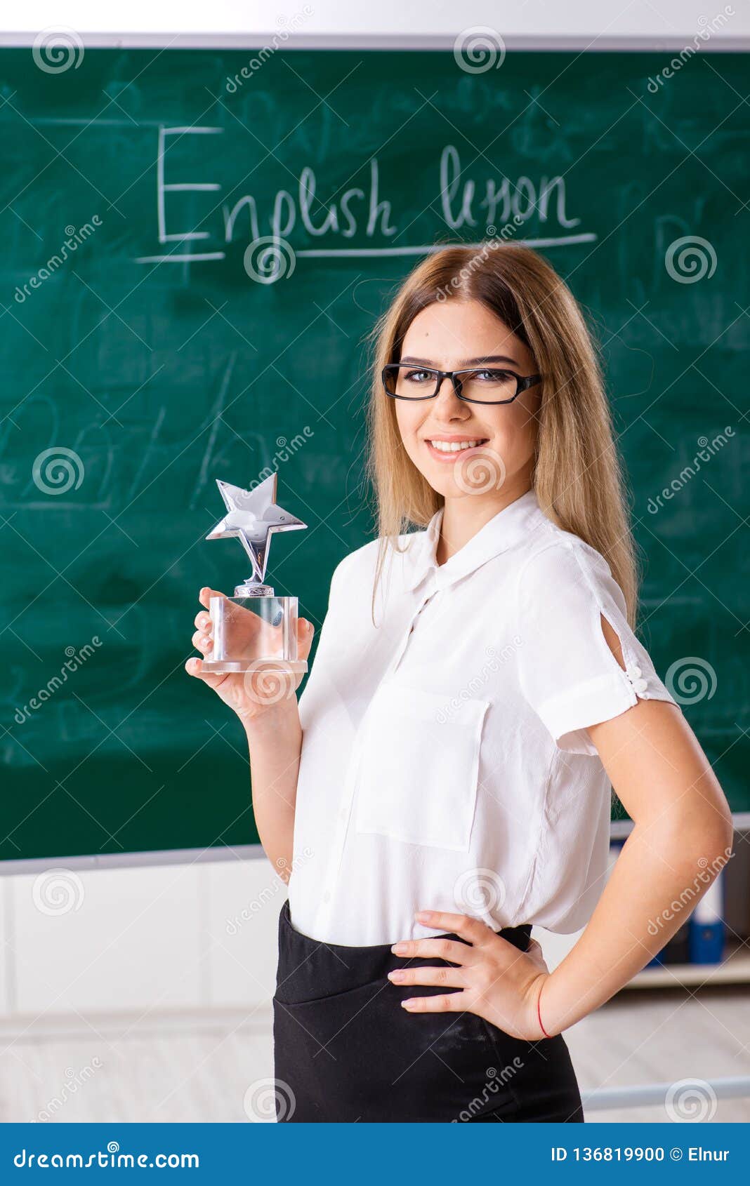 The Young Female English Language Teacher Standing in Front of the ...