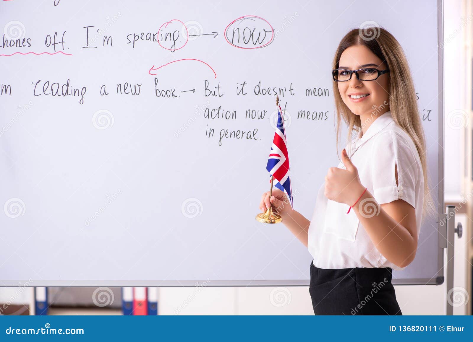 The Young Female English Language Teacher Standing in Front of the ...