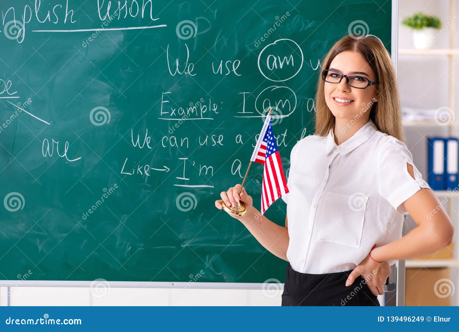 The Young Female English Language Teacher Standing in Front of the ...